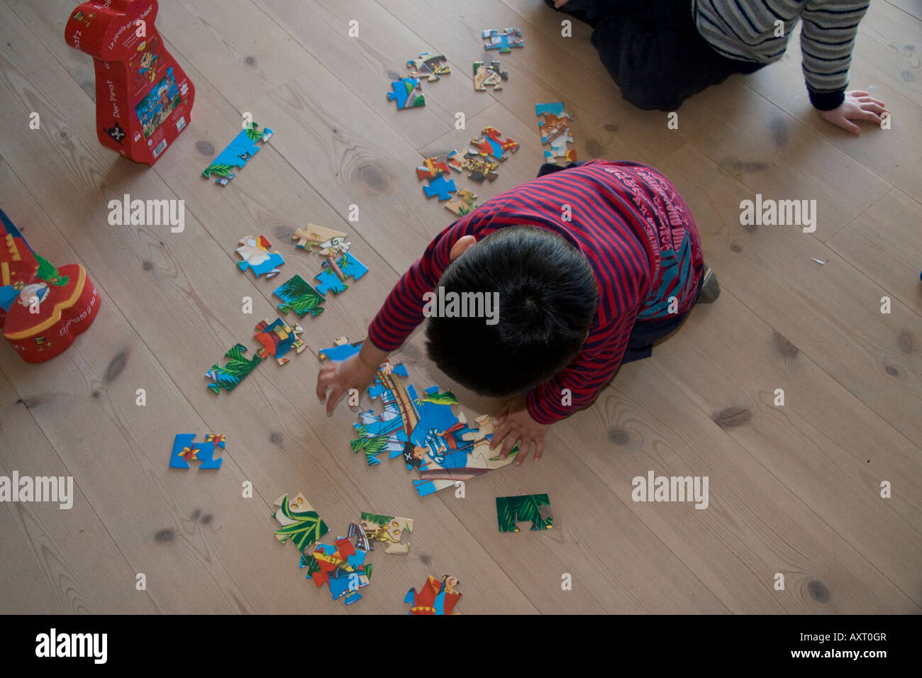 Children playing together jigsaw puzzle hi-res stock photography and ...