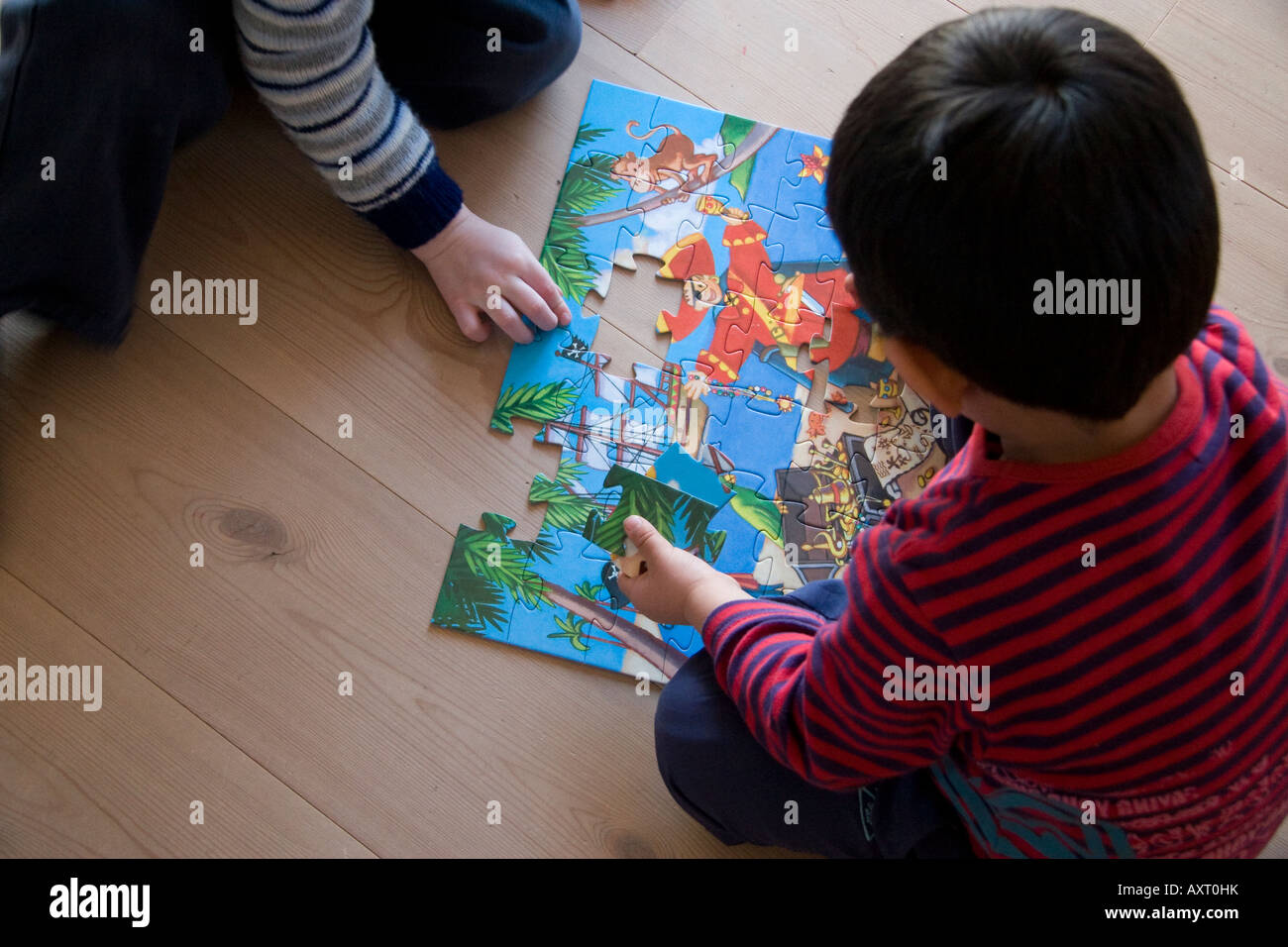 Children playing together jigsaw puzzle hi-res stock photography and ...