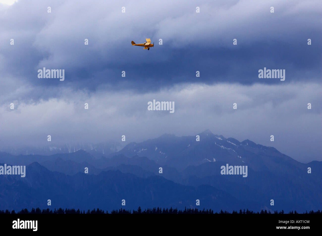 Tiger Moth Biplane Storm Clouds and Mountains near Wanaka South Island ...