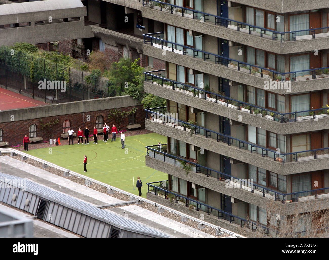 Children play in an inner city playground surrounded by high rise flats ...
