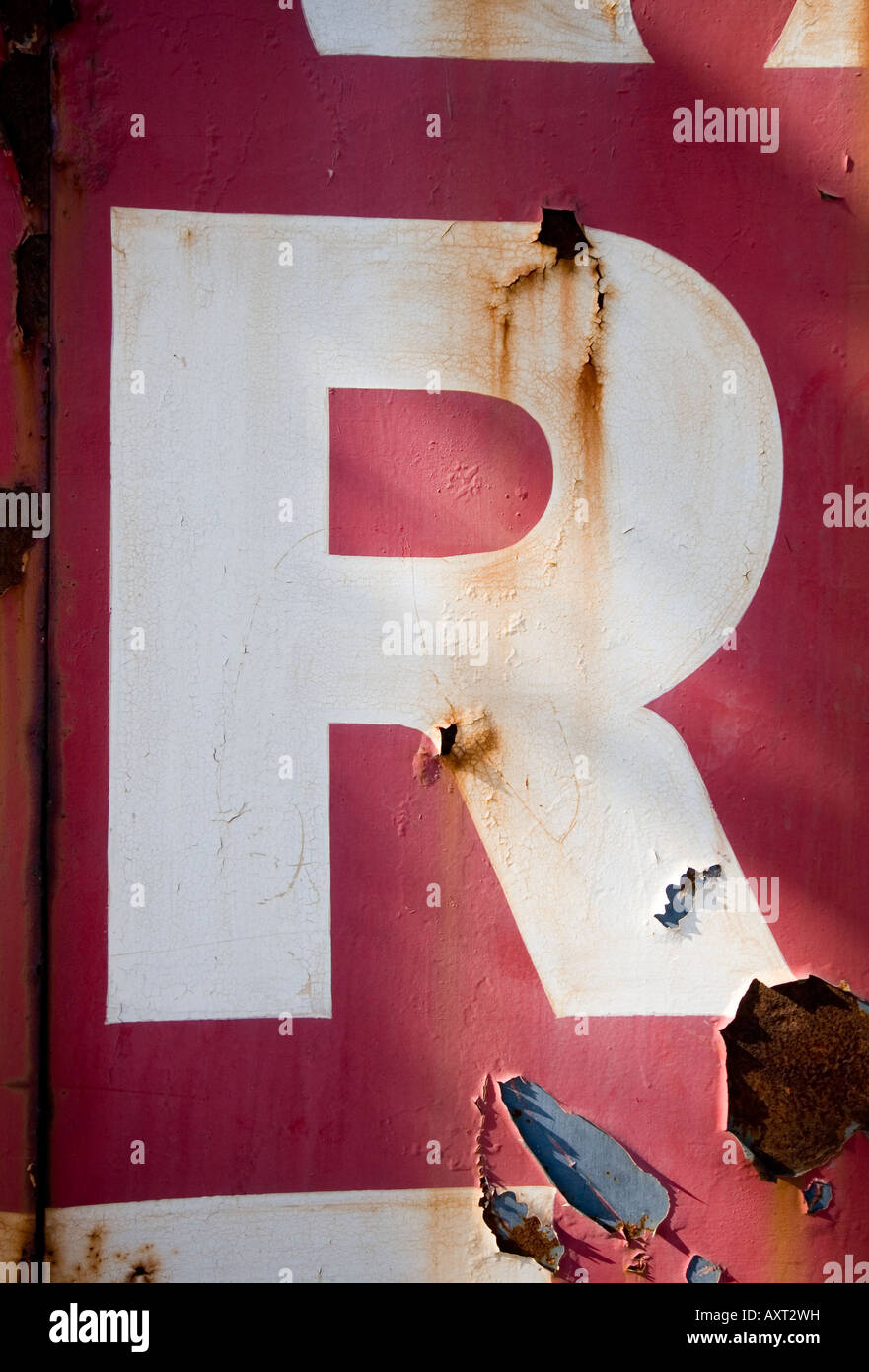 Peeling letter R on rusting disused scrap yard gates. Use for drop caps ...