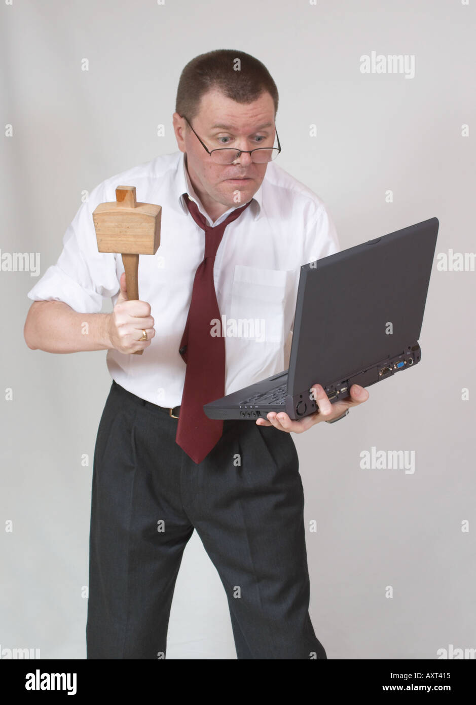 Computer Failure - A business man shows his anger with his laptop ...