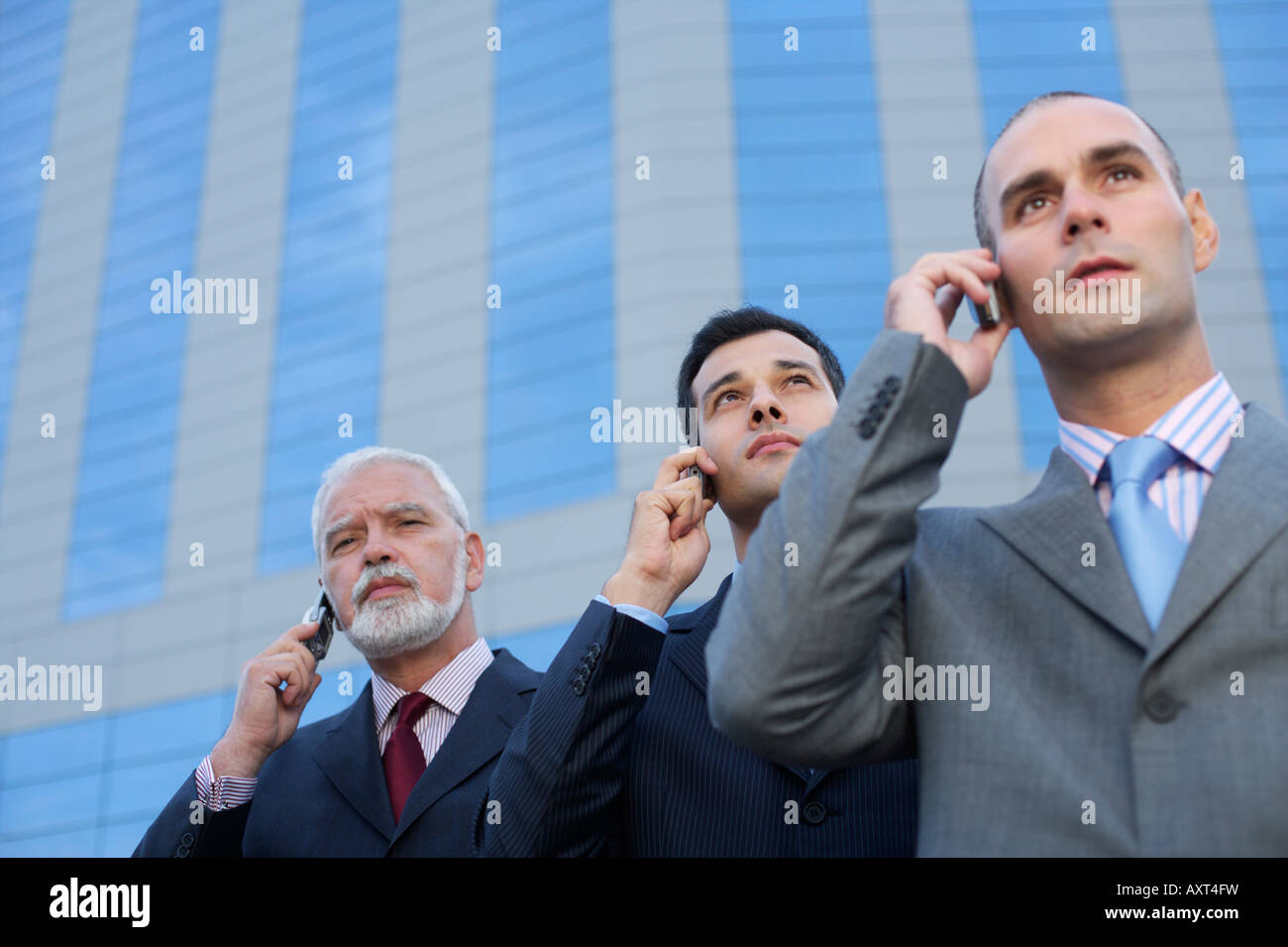 Three businessmen phoning with mobile phones Stock Photo - Alamy