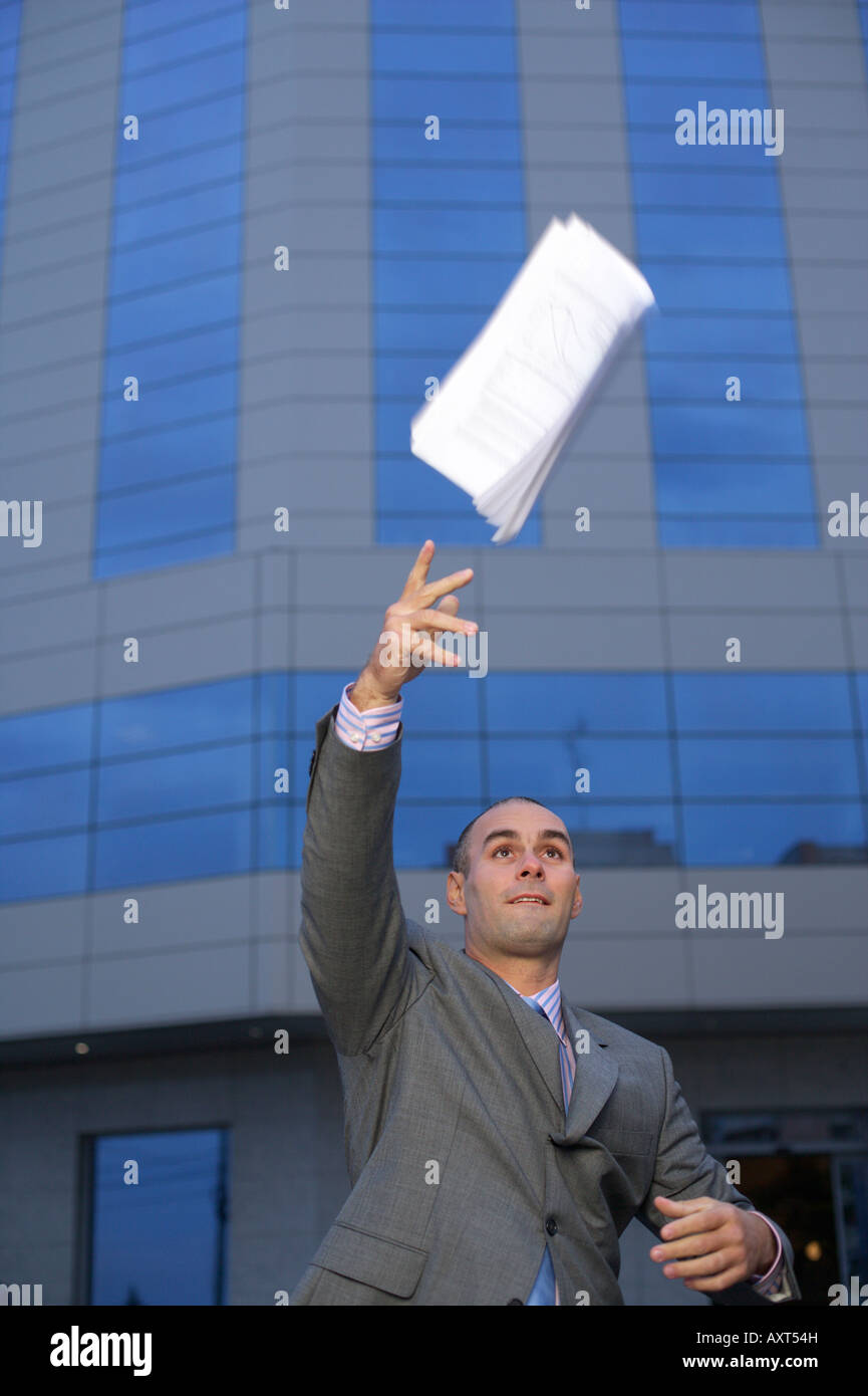 Businessman throwing papers in the air Stock Photo - Alamy