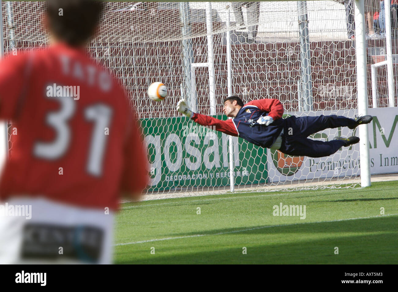 Murcia football club goalkeeper reaching for a save Stock Photo - Alamy