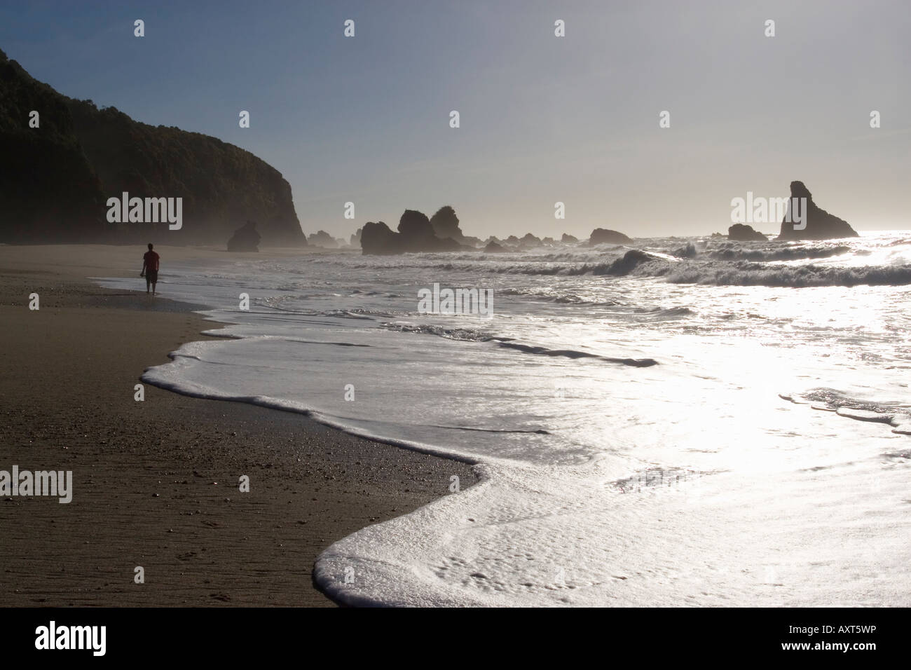 Distant Figure on Beach Stock Photo - Alamy
