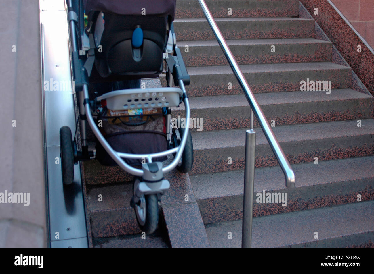 Stroller moving down a staircase Stock Photo - Alamy