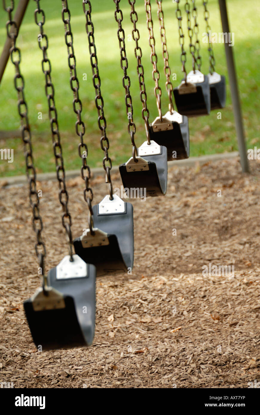 Swing set equipment on a playground Stock Photo - Alamy