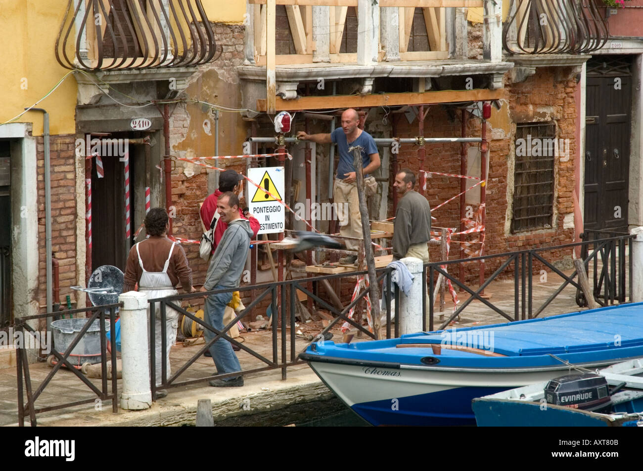 Workmen repairing damage caused by flooding in Venice, Italy, Europe ...