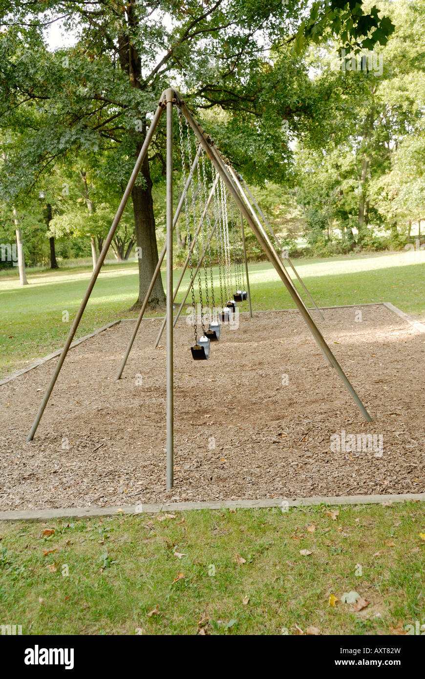 Swing set equipment on a playground Stock Photo - Alamy
