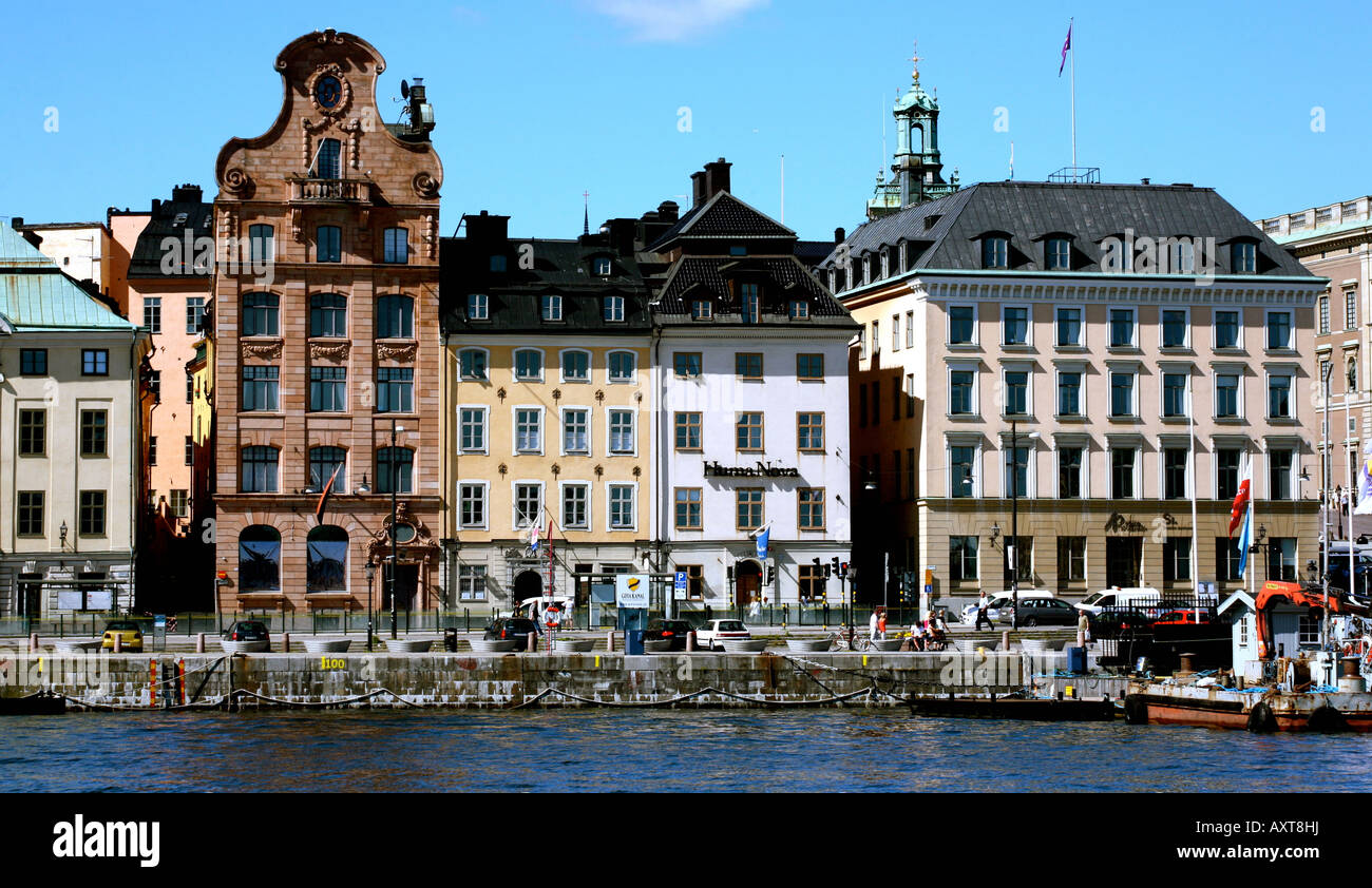 Large colorful brick buildings line the water front Stock Photo - Alamy