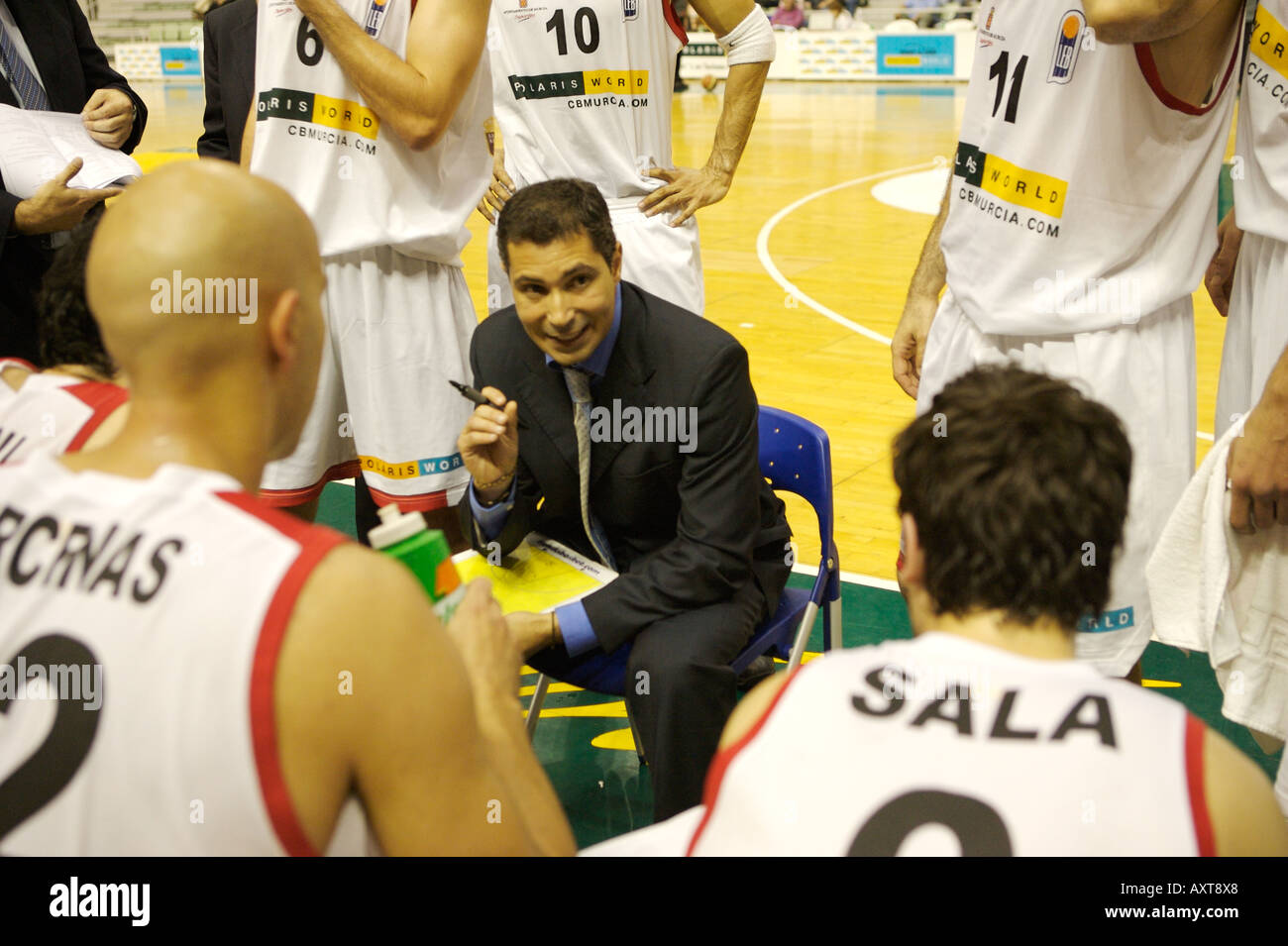 A coach giving some tactical advice during a time out Stock Photo - Alamy