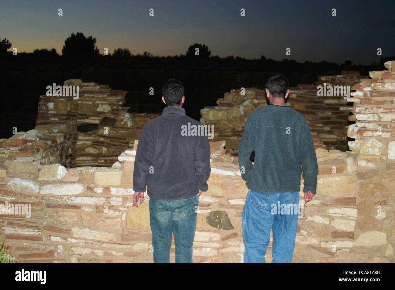 Two men in front of stone ruins Stock Photo - Alamy