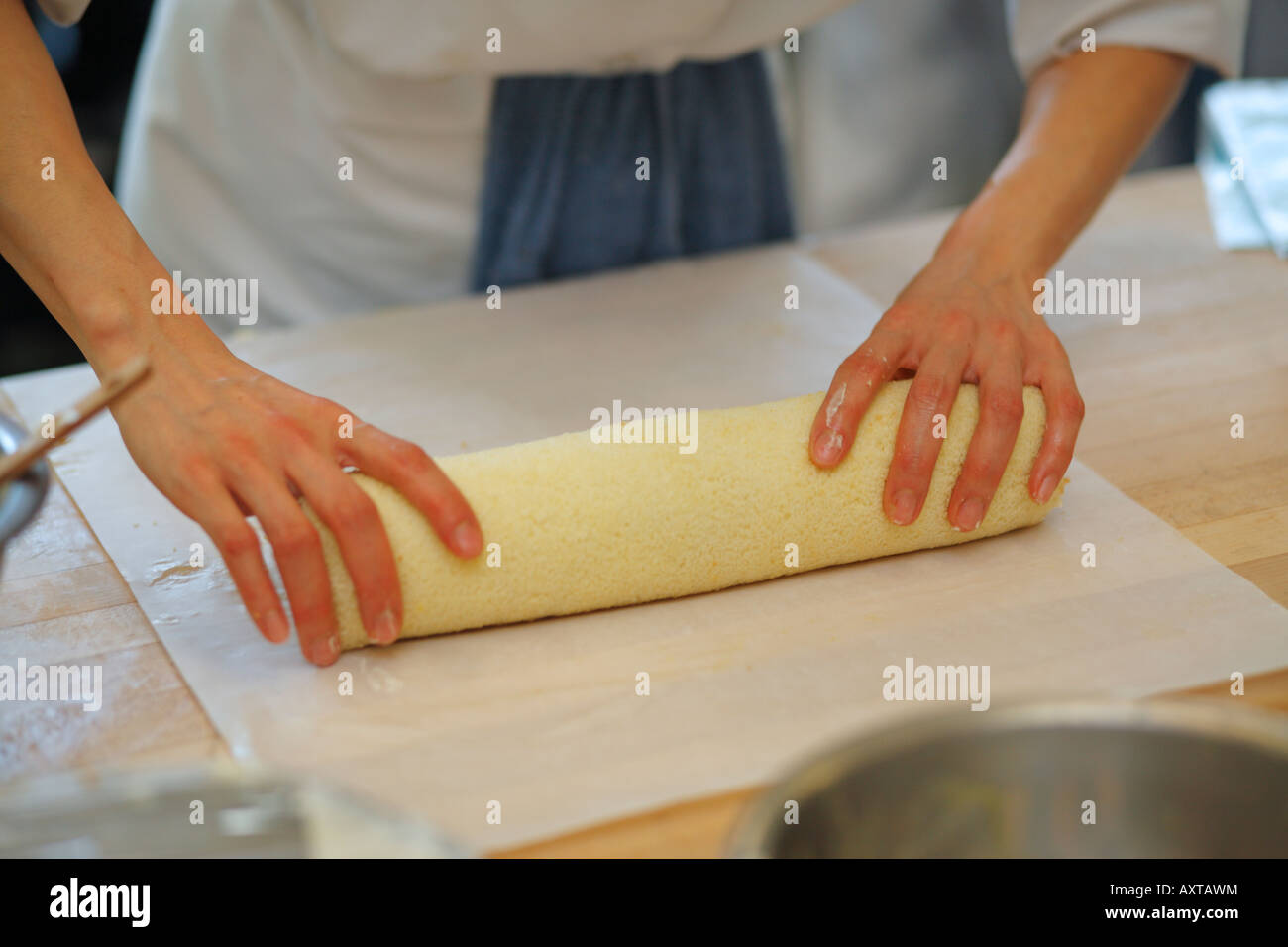 Pastry chef rolling up swiss roll Stock Photo - Alamy