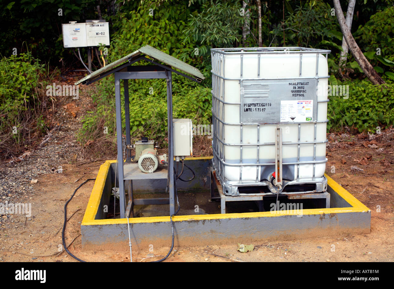Chemical injector beside an oil well platform in the Ecuadorian Amazon ...