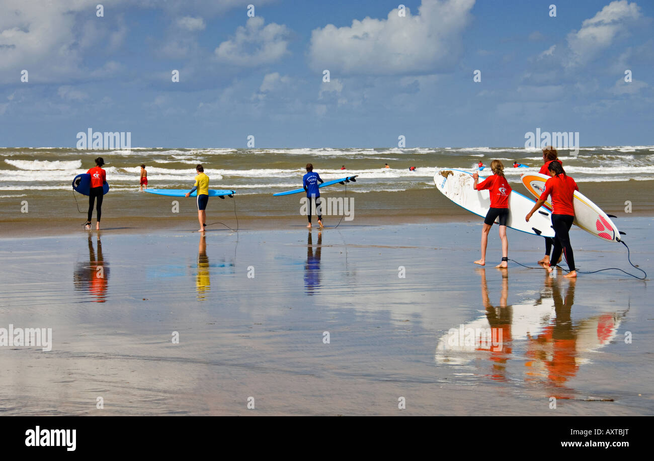 Surfers on the beach Stock Photo - Alamy