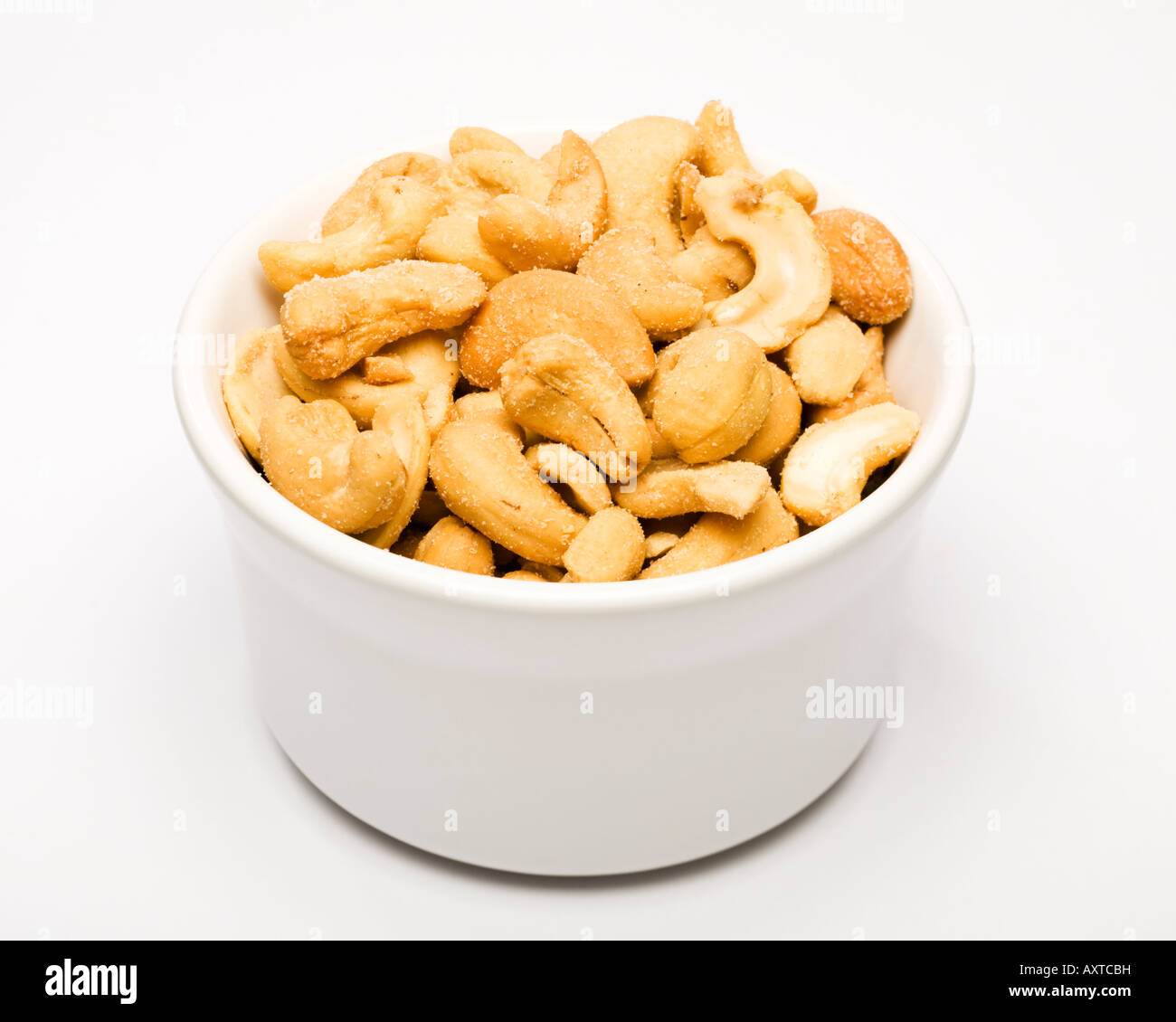 Salted Cashew nuts in a white bowl Stock Photo - Alamy