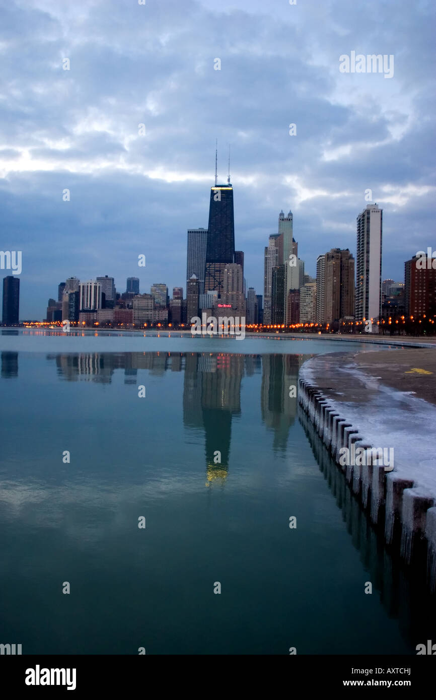 The John Hancock Building is reflected in the calm waters of Lake ...