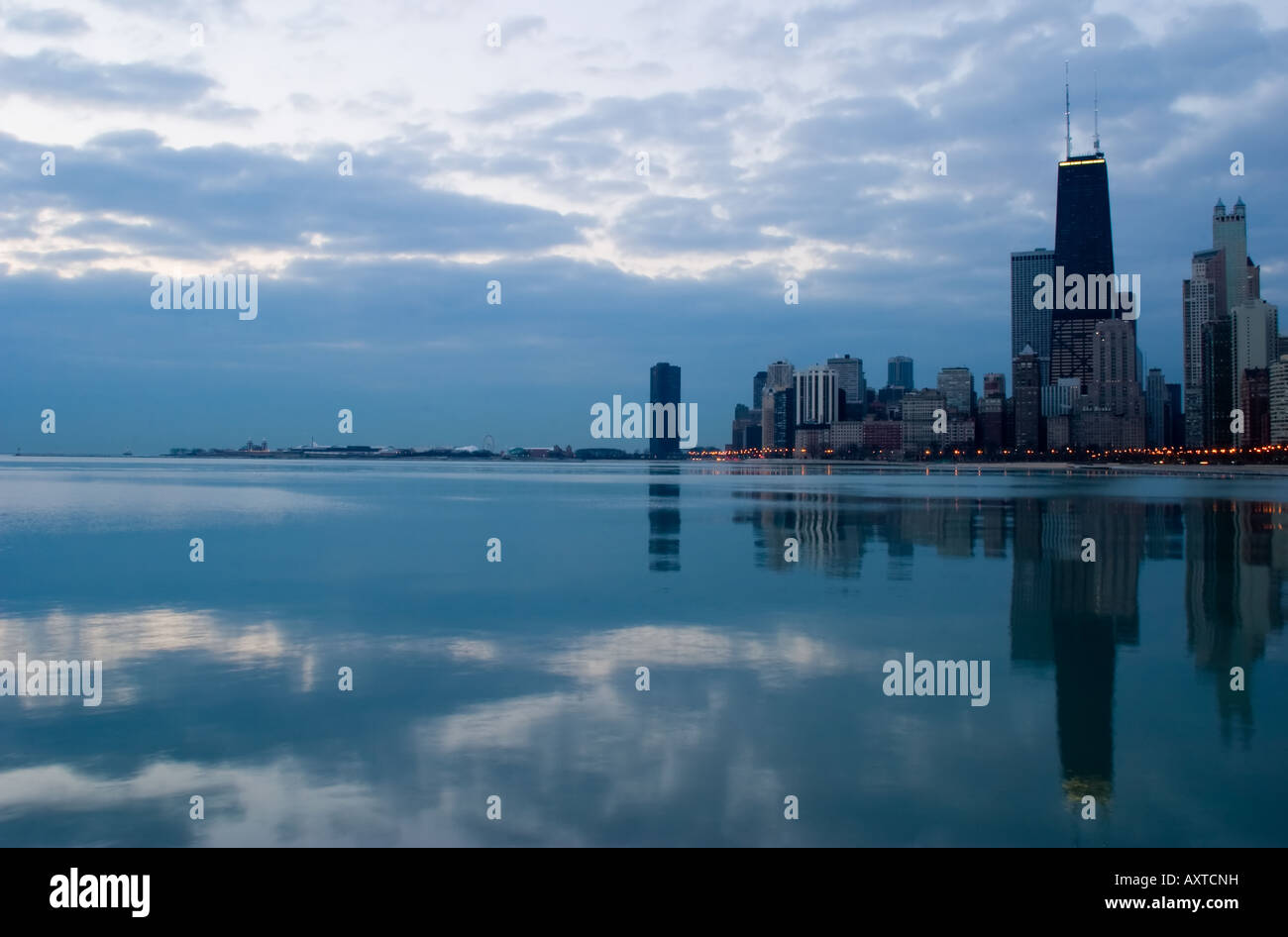 The John Hancock Building is reflected in the calm waters of Lake ...