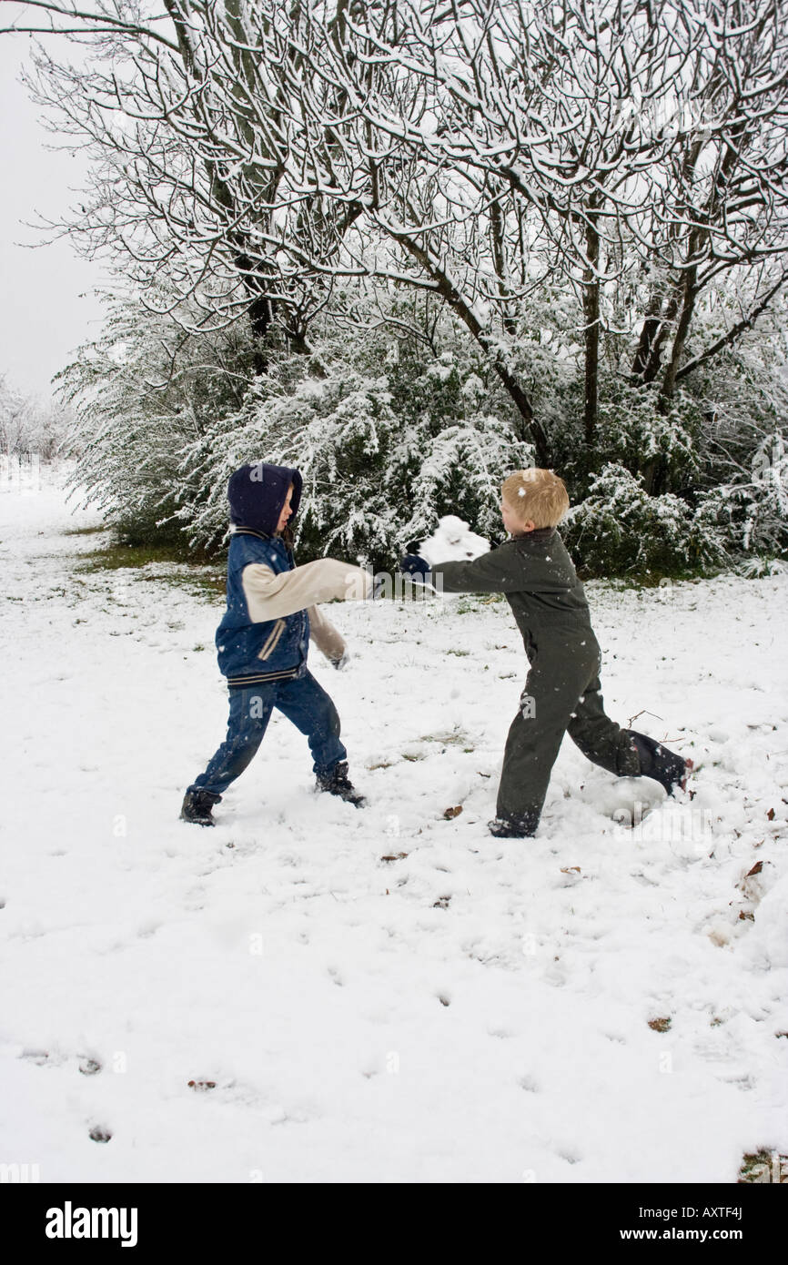 Boys playing snowball fights in the snow Stock Photo - Alamy