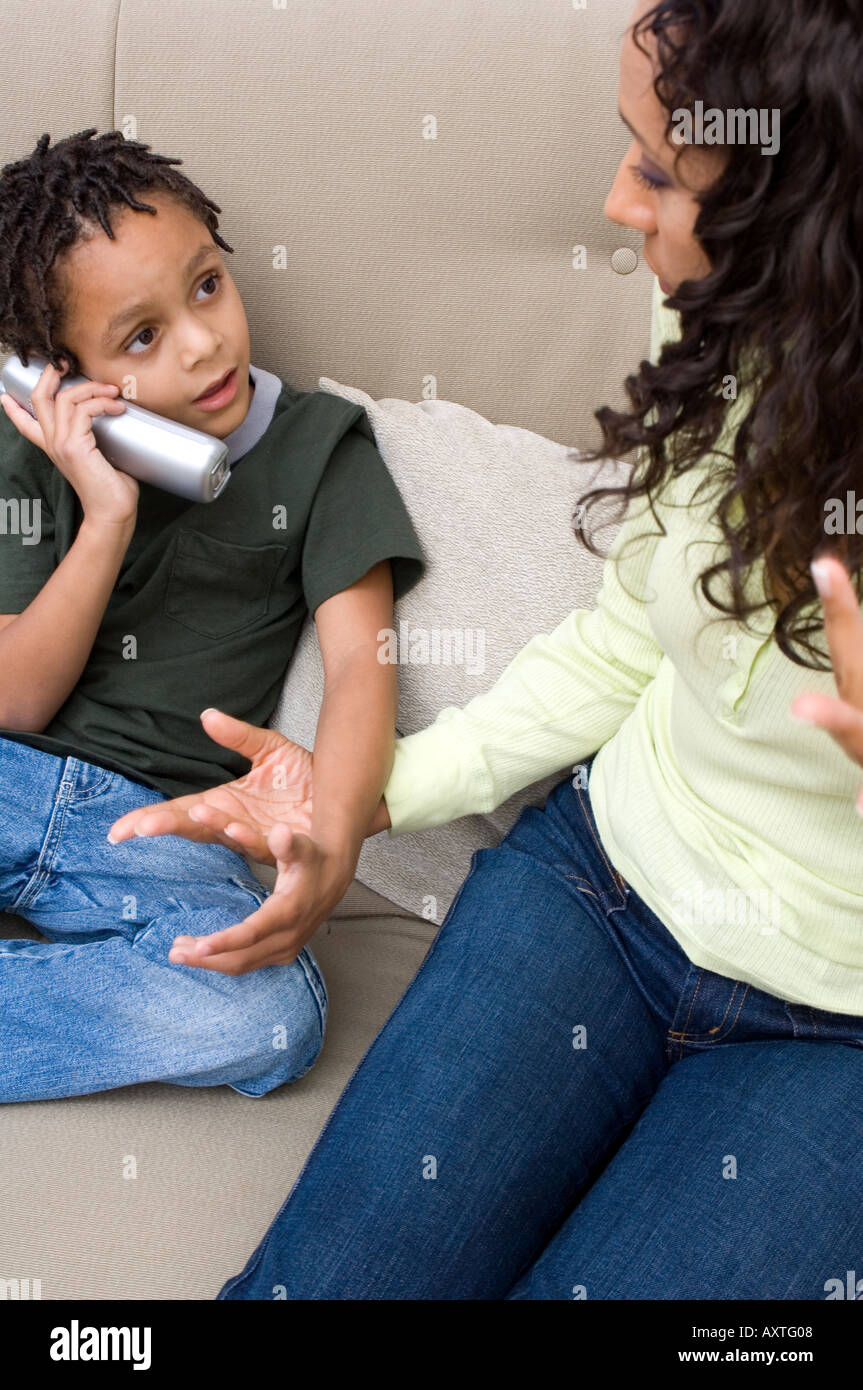 Portrait of boy on the phone ignoring his mom Stock Photo - Alamy