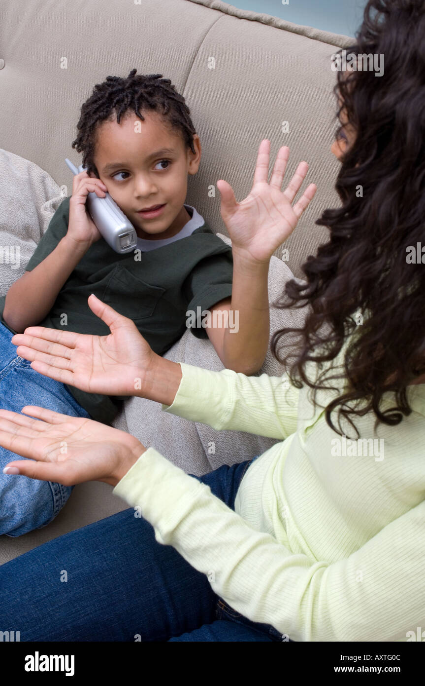 Portrait of boy on the phone ignoring his mom Stock Photo - Alamy