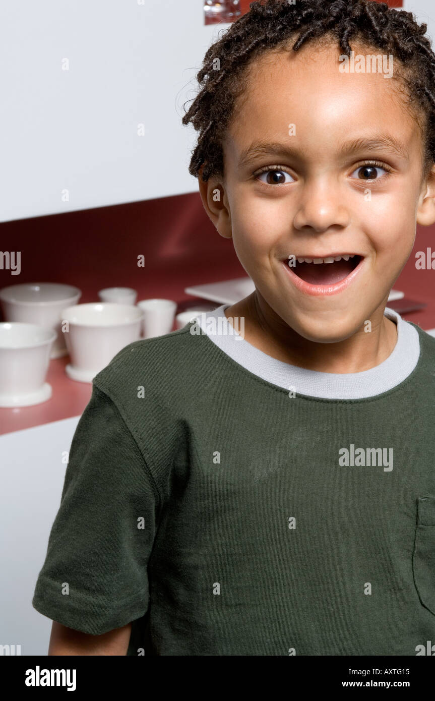 Portrait of a young boy acting shocked Stock Photo - Alamy