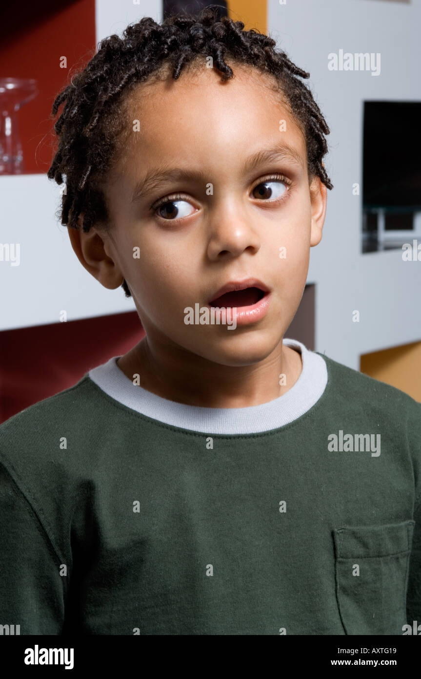 Portrait of a young boy acting shocked Stock Photo - Alamy