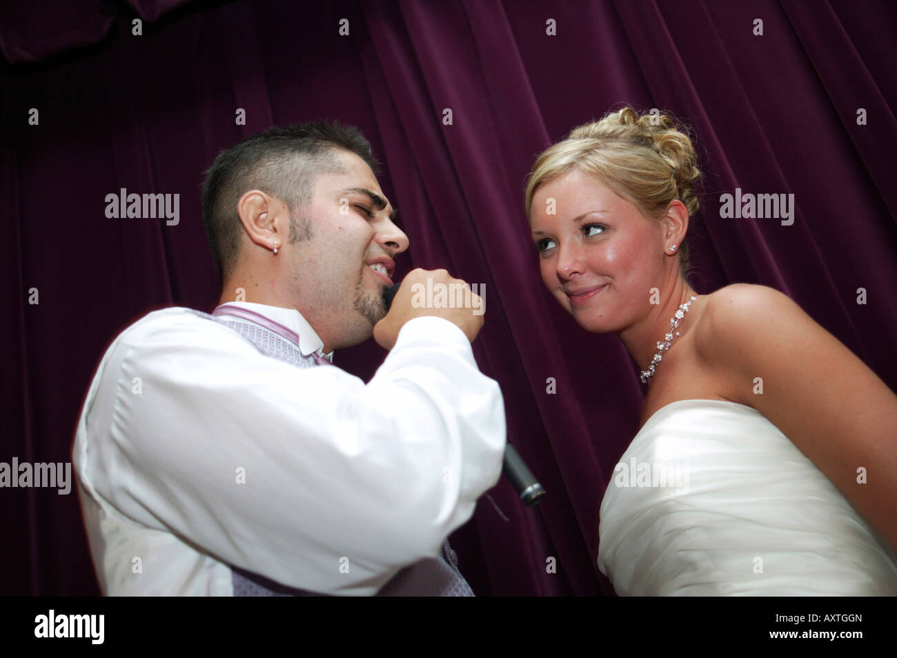 Wedding day moment groom singing to the bride during reception with ...