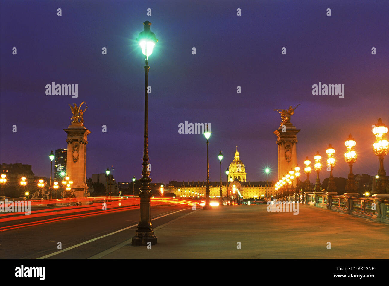 Pont Alexandre III traffic with lamp lights and Hotel des Invalides at ...