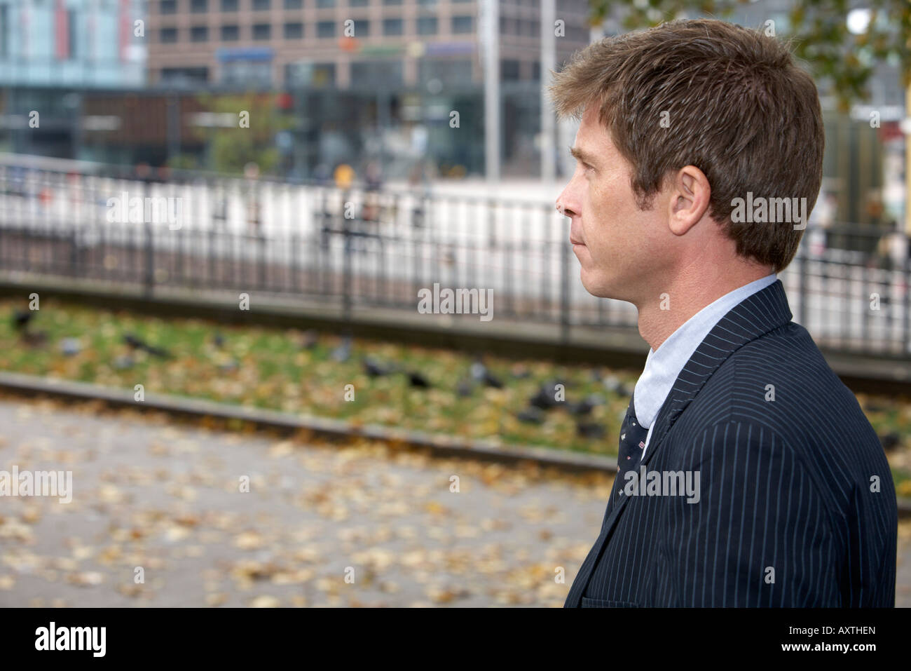 Portrait of man on city street side profile Stock Photo - Alamy
