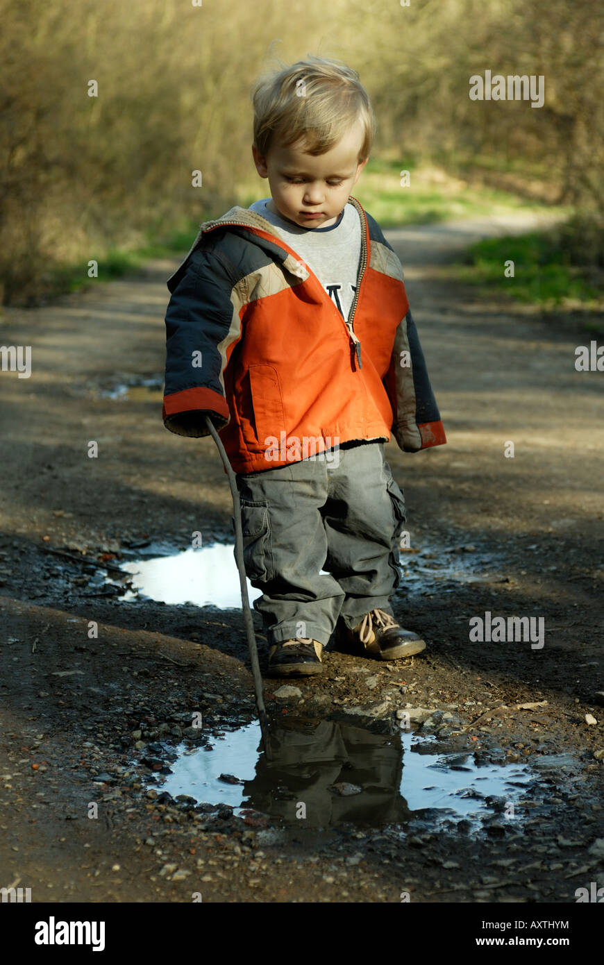 Toddler playing in mud puddle hi-res stock photography and images - Alamy