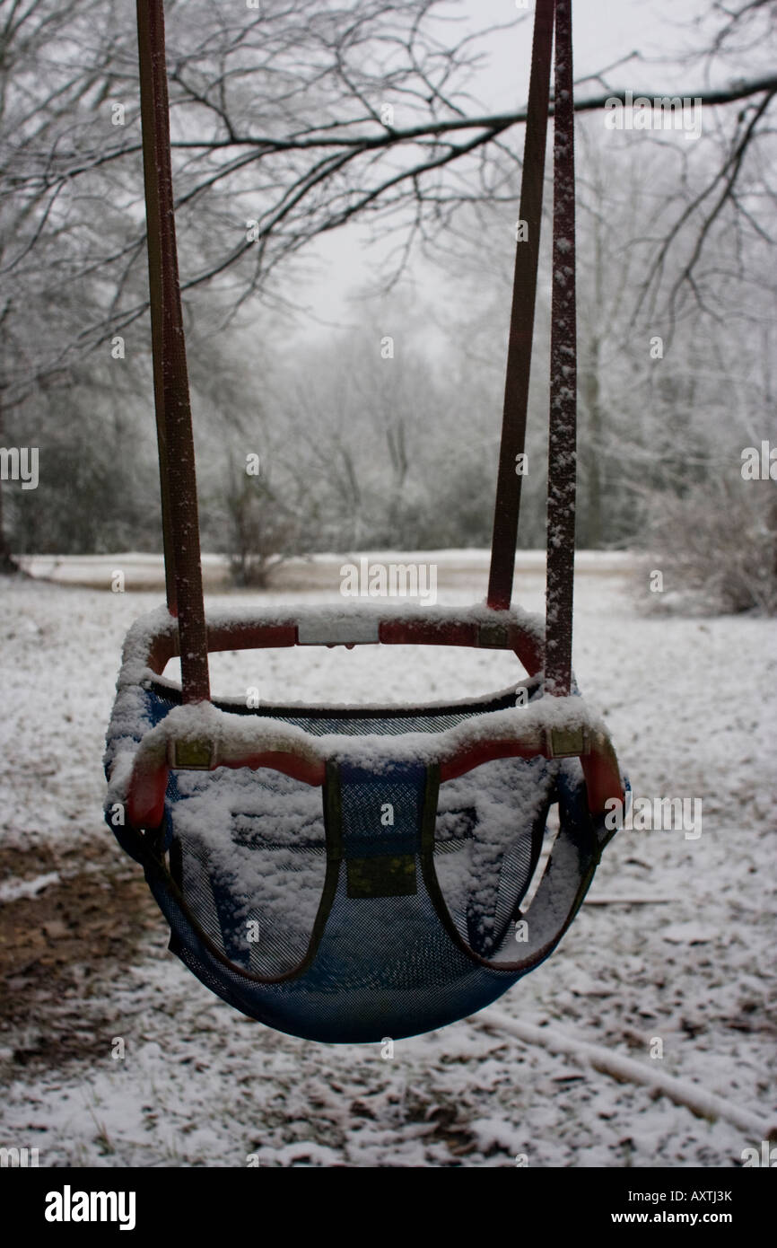 Baby swing in the snow Stock Photo - Alamy