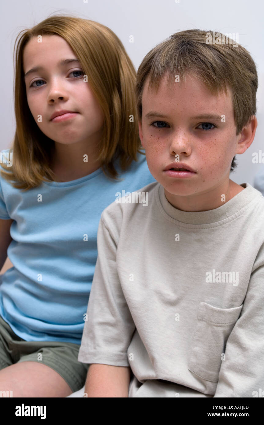 Portrait of two young kids being bored Stock Photo - Alamy
