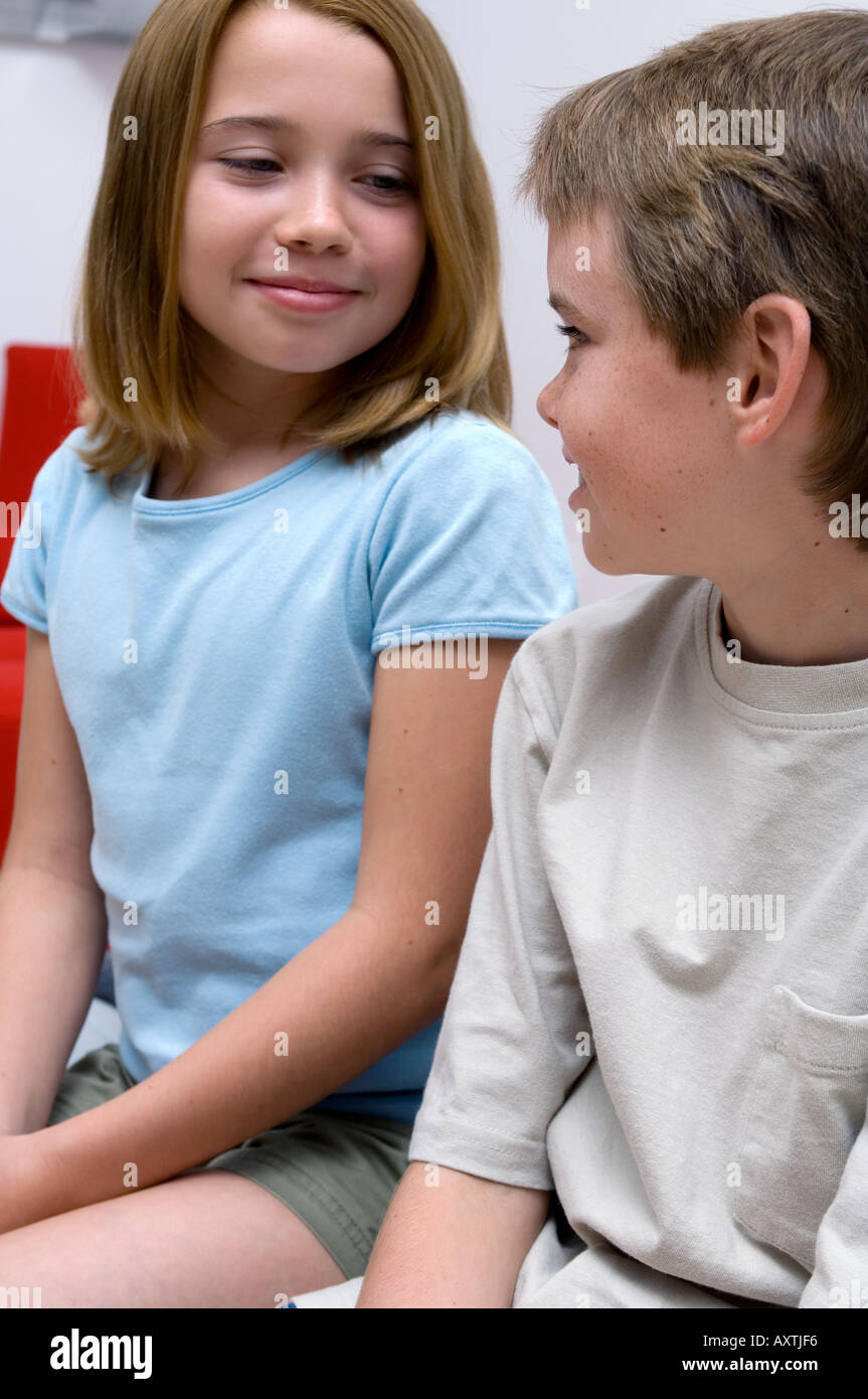 Two young kids talking and laughing with each other Stock Photo - Alamy