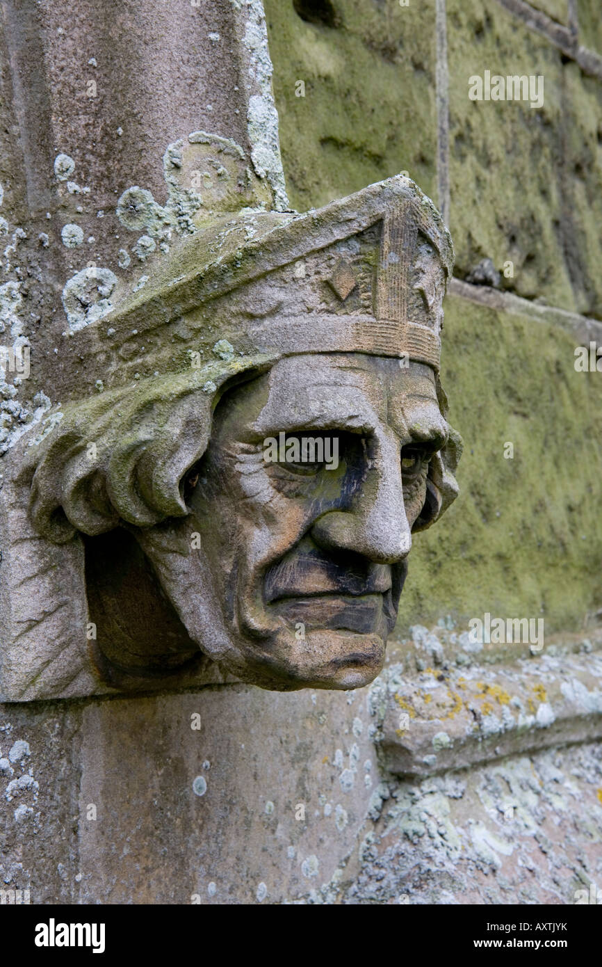 A scary gargoyle of a face on the doorway of the Church of St. Helen at ...