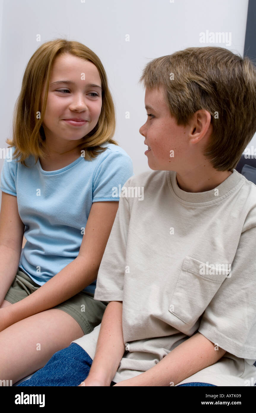 Two young kids talking and laughing with each other Stock Photo - Alamy