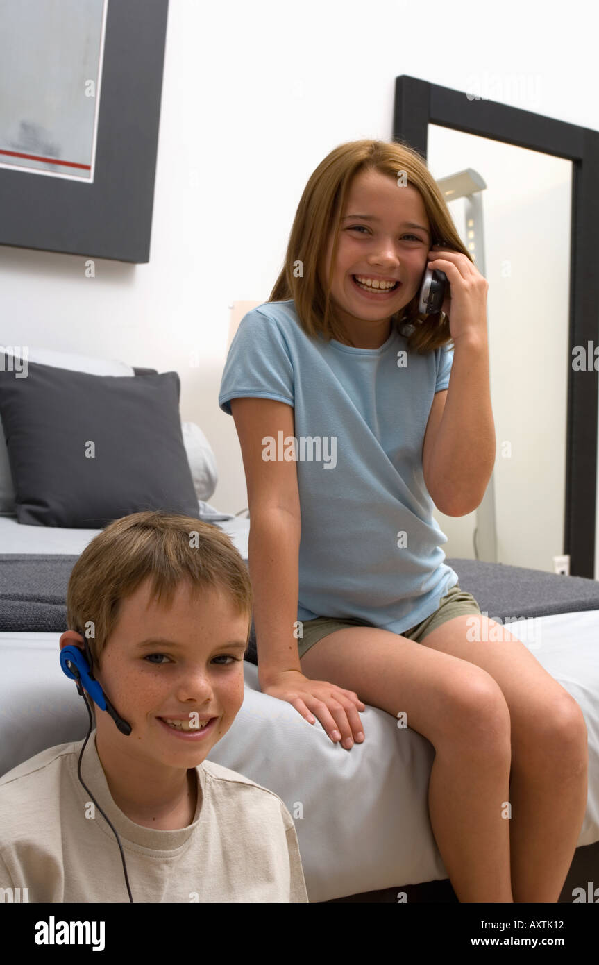 Portrait of two young kids on the telephone Stock Photo - Alamy