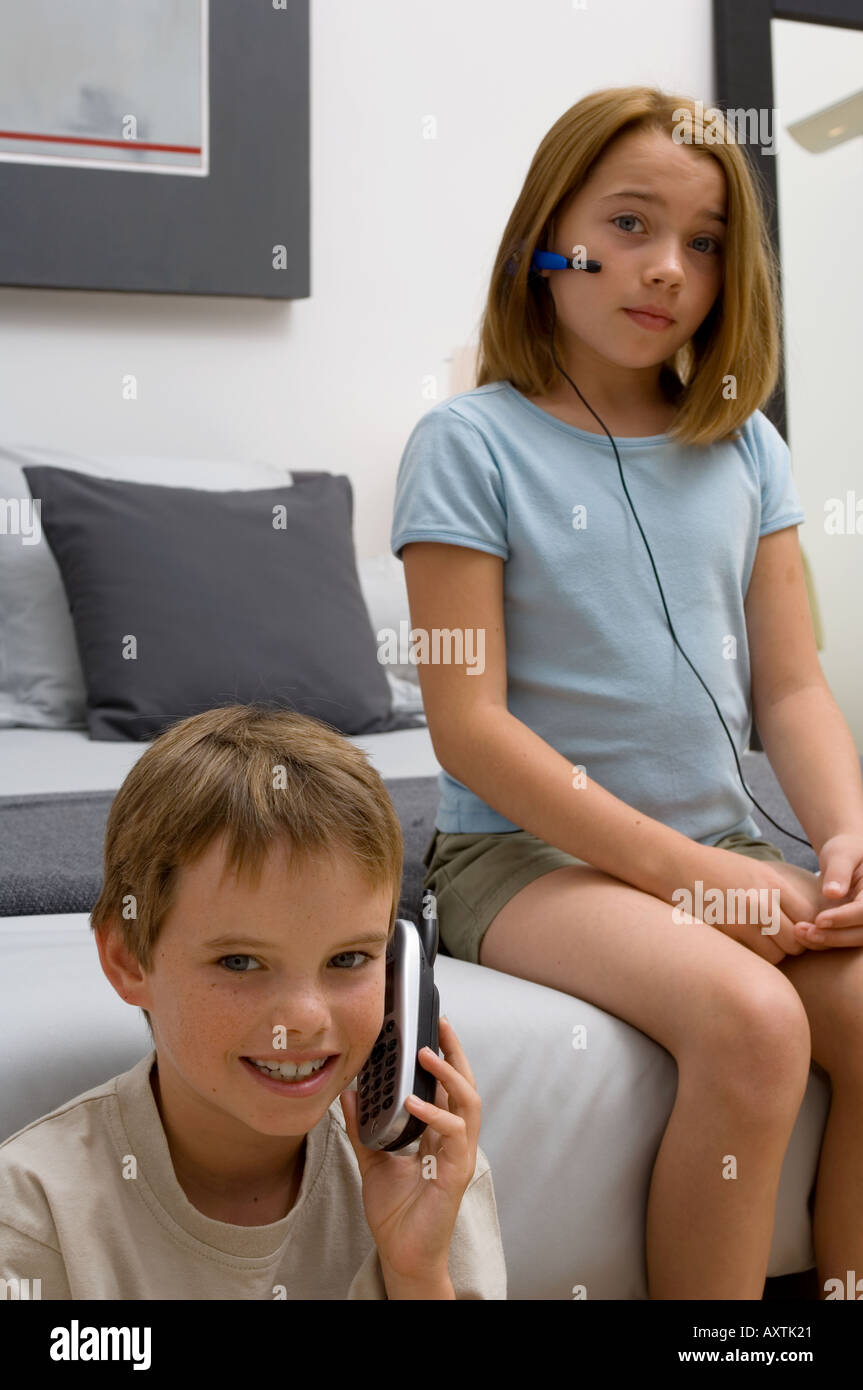 Portrait of two young kids on the telephone Stock Photo - Alamy