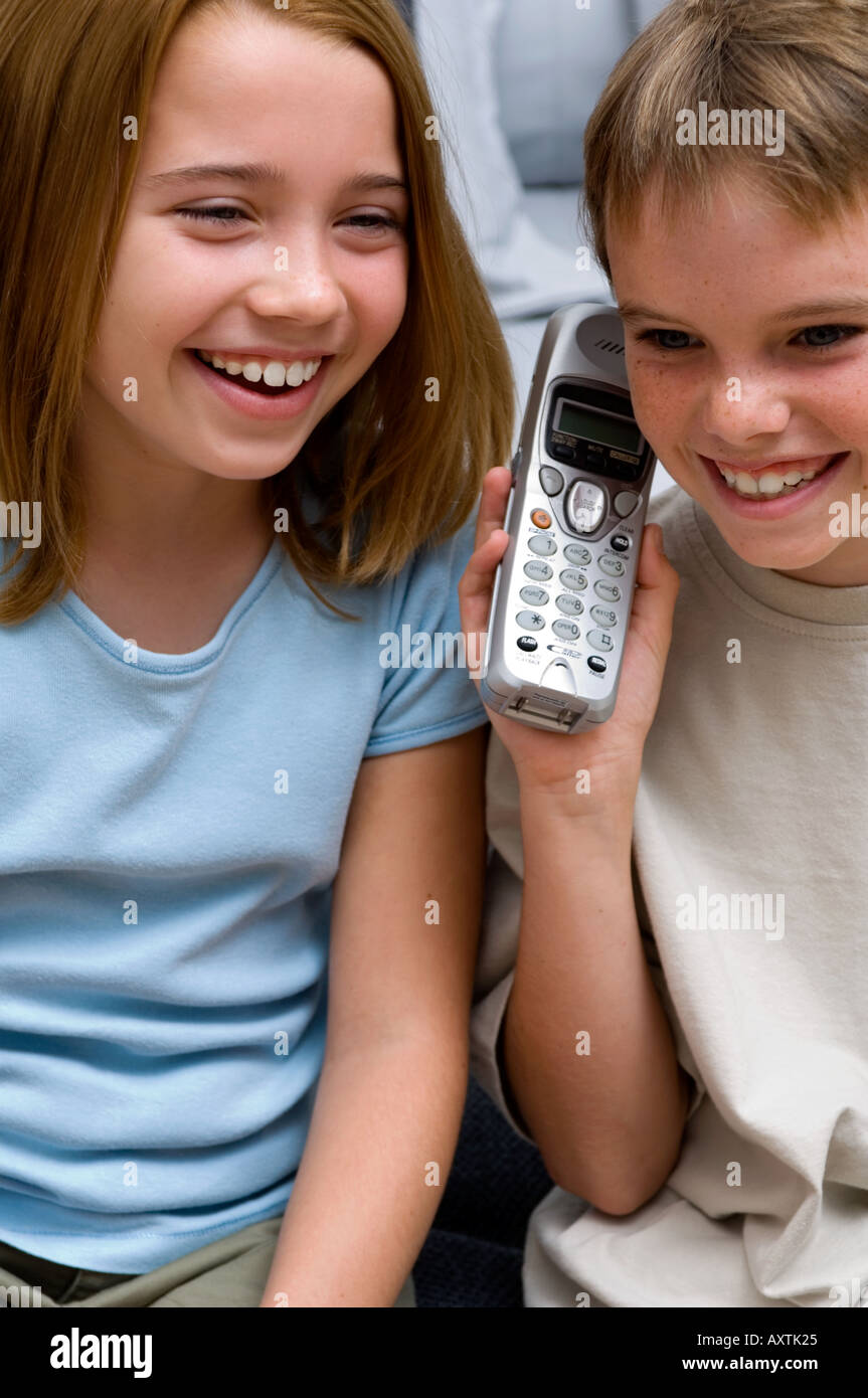 Portrait of two young kids on the telephone Stock Photo - Alamy