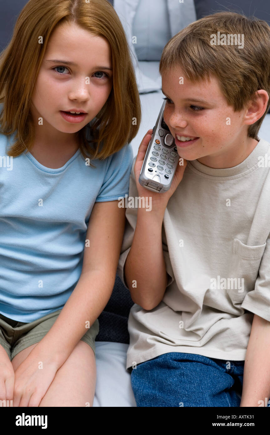 Portrait of two young kids on the telephone Stock Photo - Alamy
