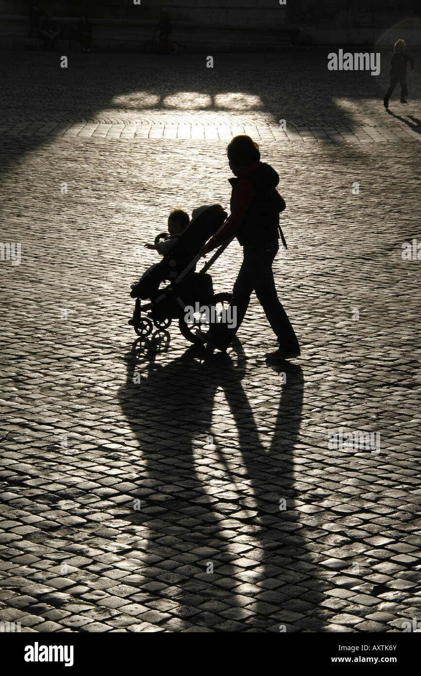 mother pushing pram in town Stock Photo - Alamy