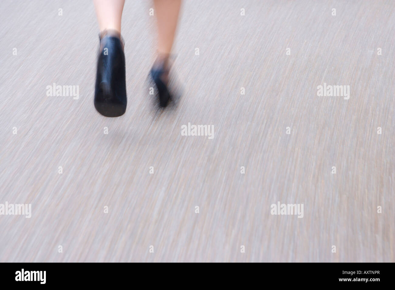 Feet of woman walking on street Stock Photo - Alamy