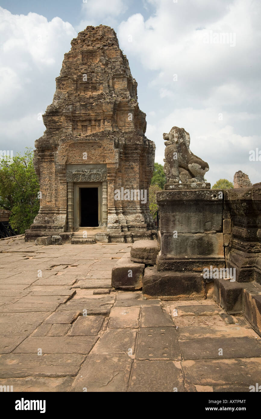 Statue of a lion with one of the towers at Preah Rup Temple in Cambodia ...
