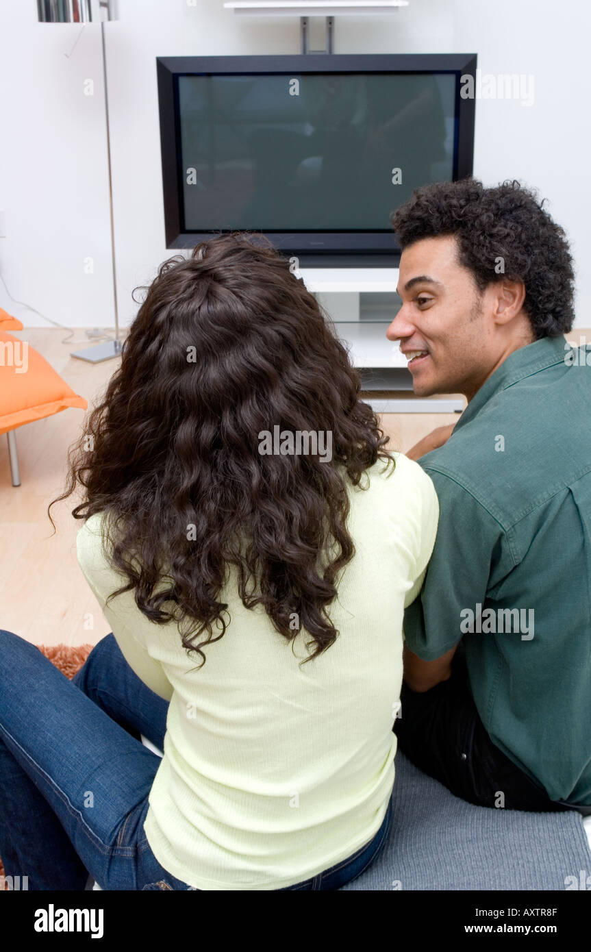 Portrait of a young couple watching TV Stock Photo - Alamy