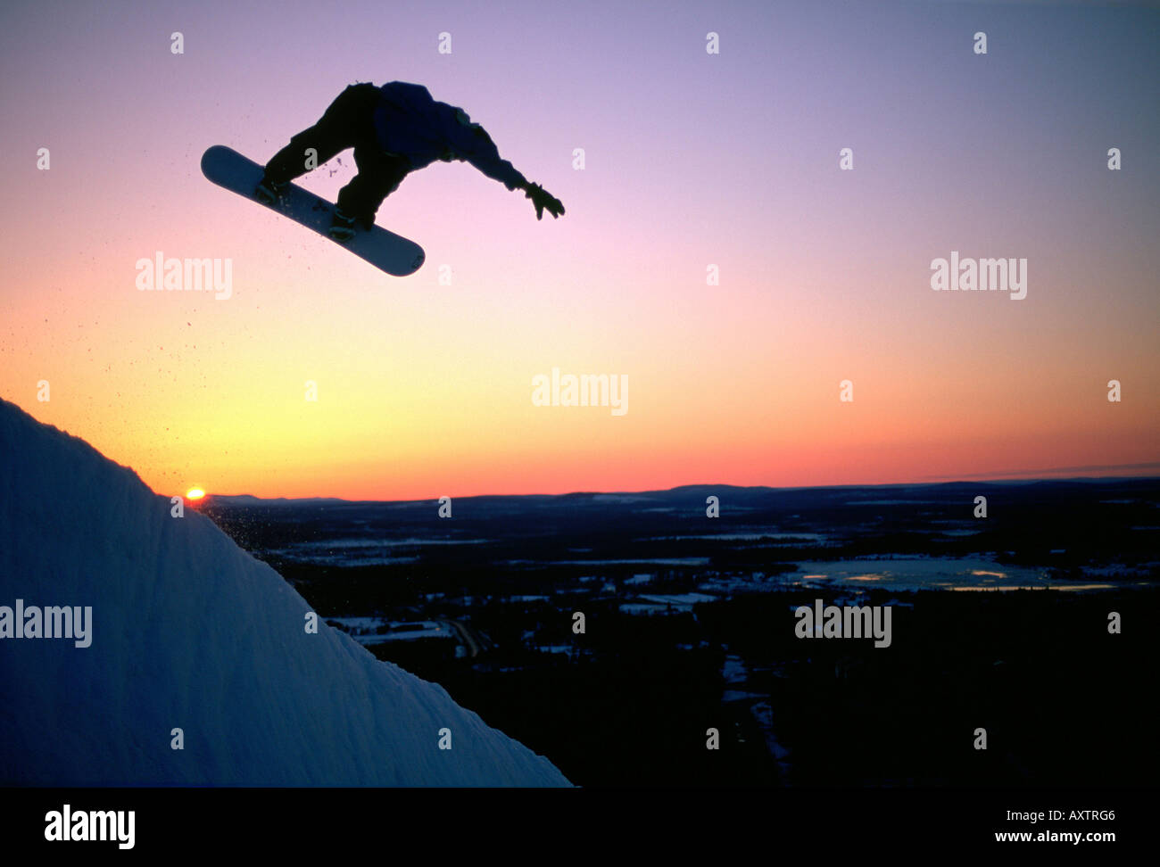 Silhouette of person performing stunt on snowboard Stock Photo - Alamy