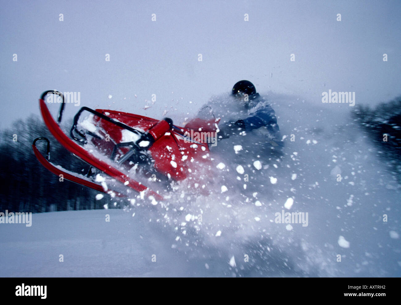 Side profile of a man riding a snowmobile Stock Photo - Alamy