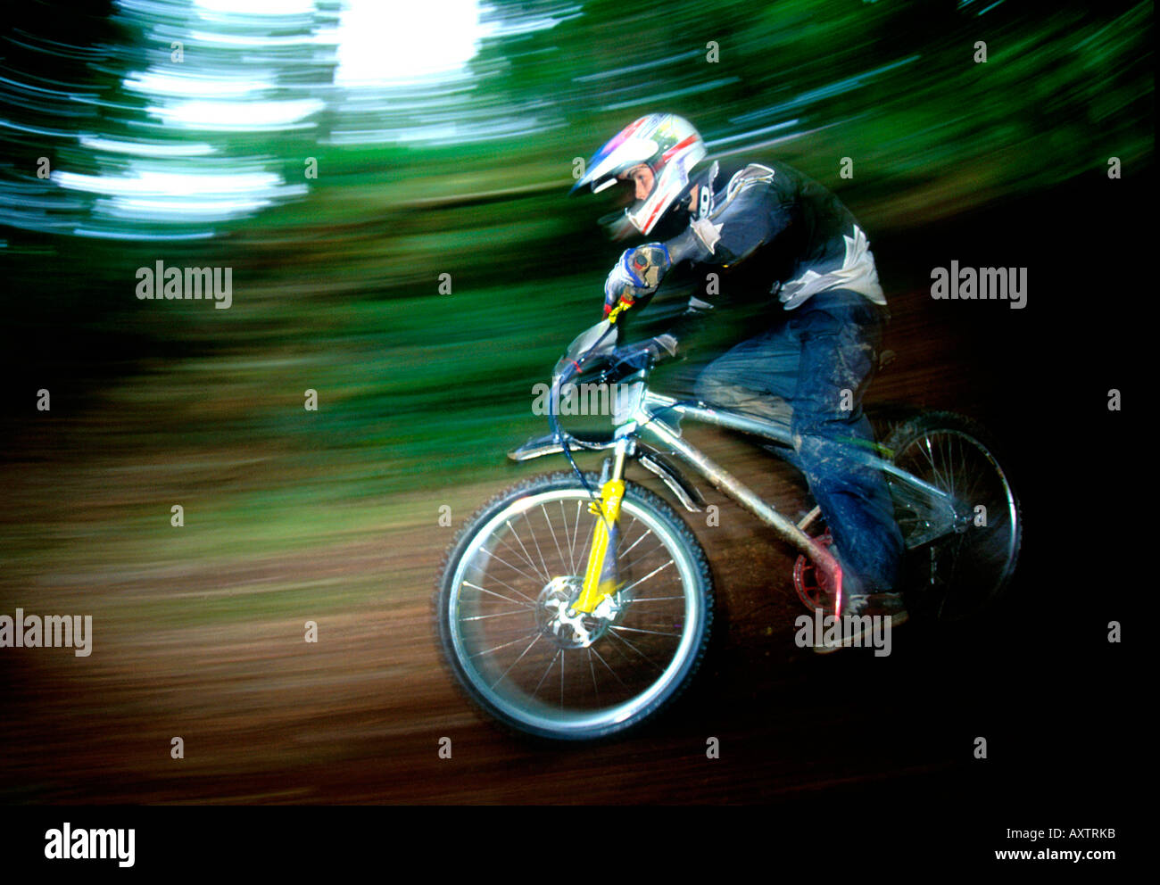 Side profile of a teenage boy riding a bicycle Stock Photo - Alamy