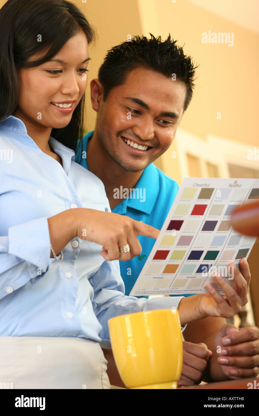 Close-up of a young couple choosing color from a color swatch Stock ...