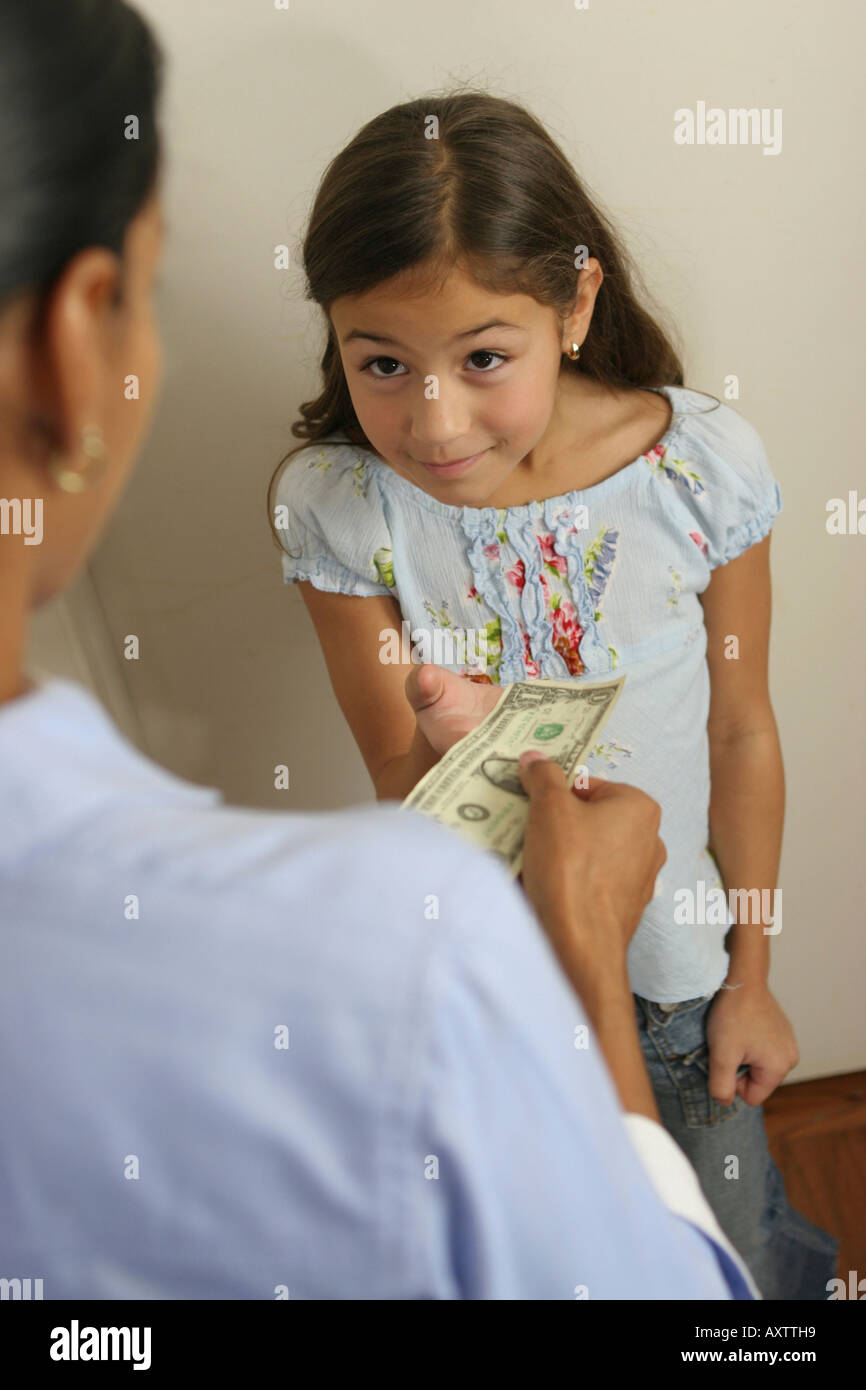 High angle view of a mother giving money to her daughter Stock Photo ...